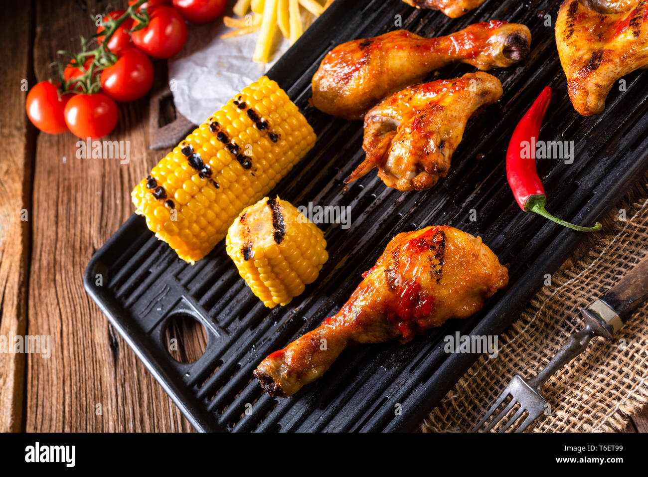 Rustic Grilled chicken wings,legs,and spicy corn Stock Photo - Alamy