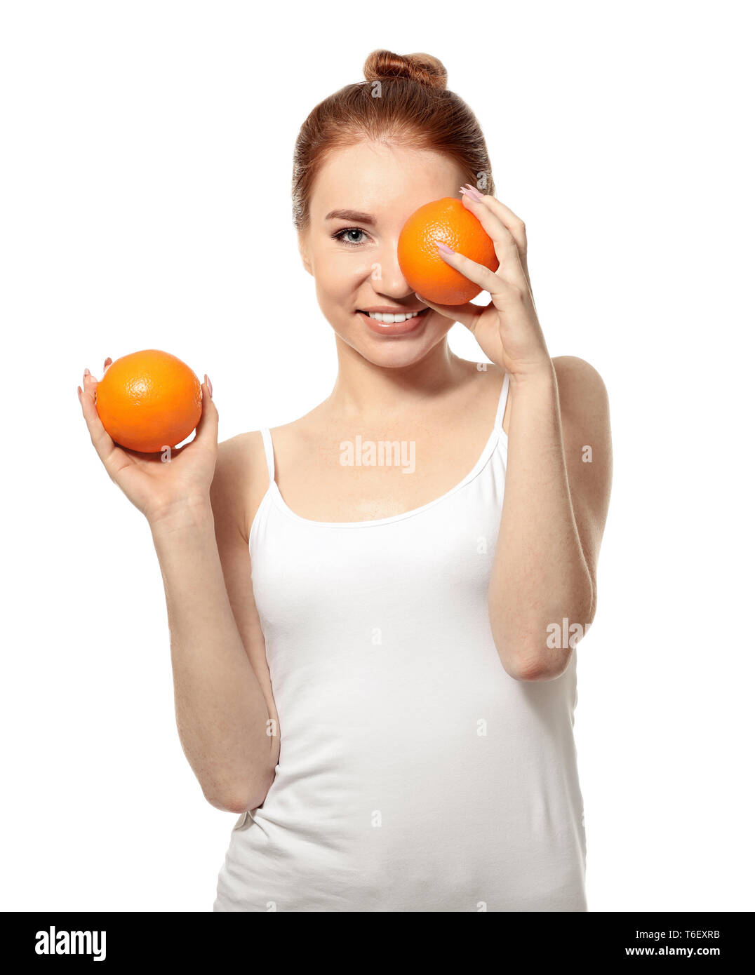 Beautiful young woman with citrus fruit on white background Stock Photo ...