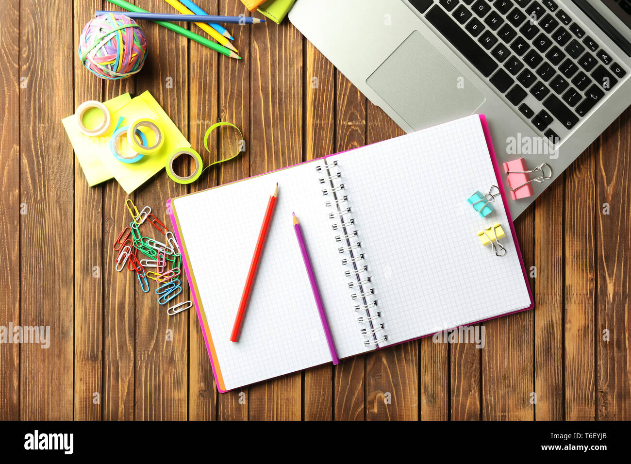 Laptop, notebook and stationery on wooden background, flat lay ...