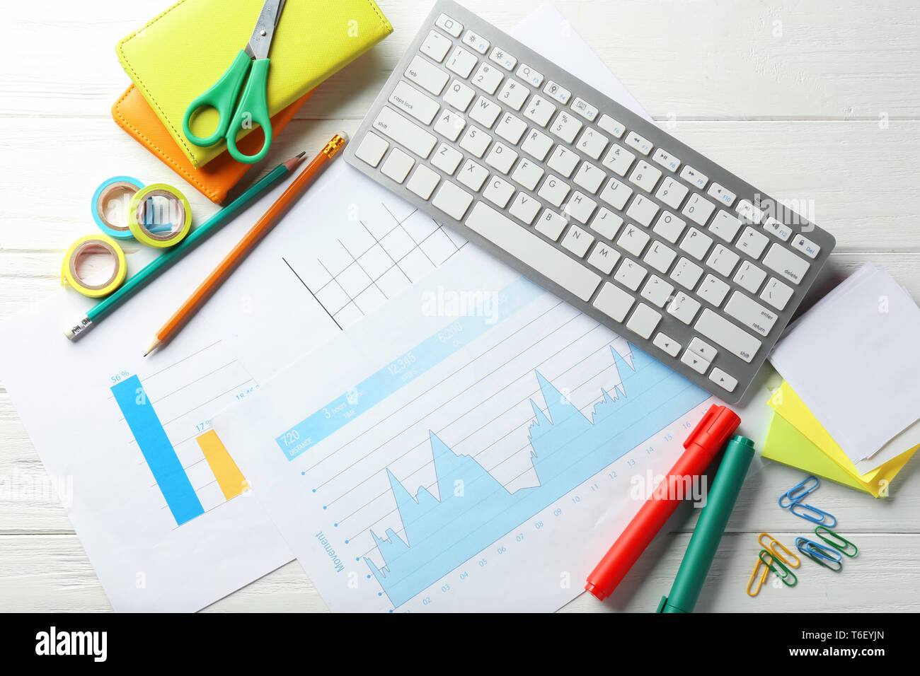 Computer keyboard, documents and stationery on wooden background, flat ...