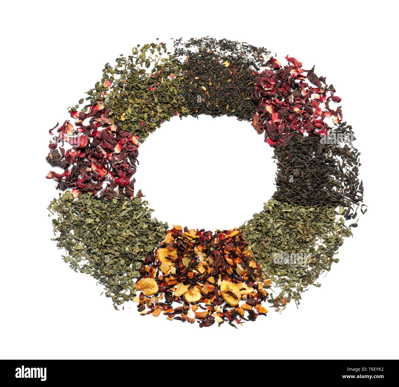 Circle made of different types of dry tea leaves on white background ...