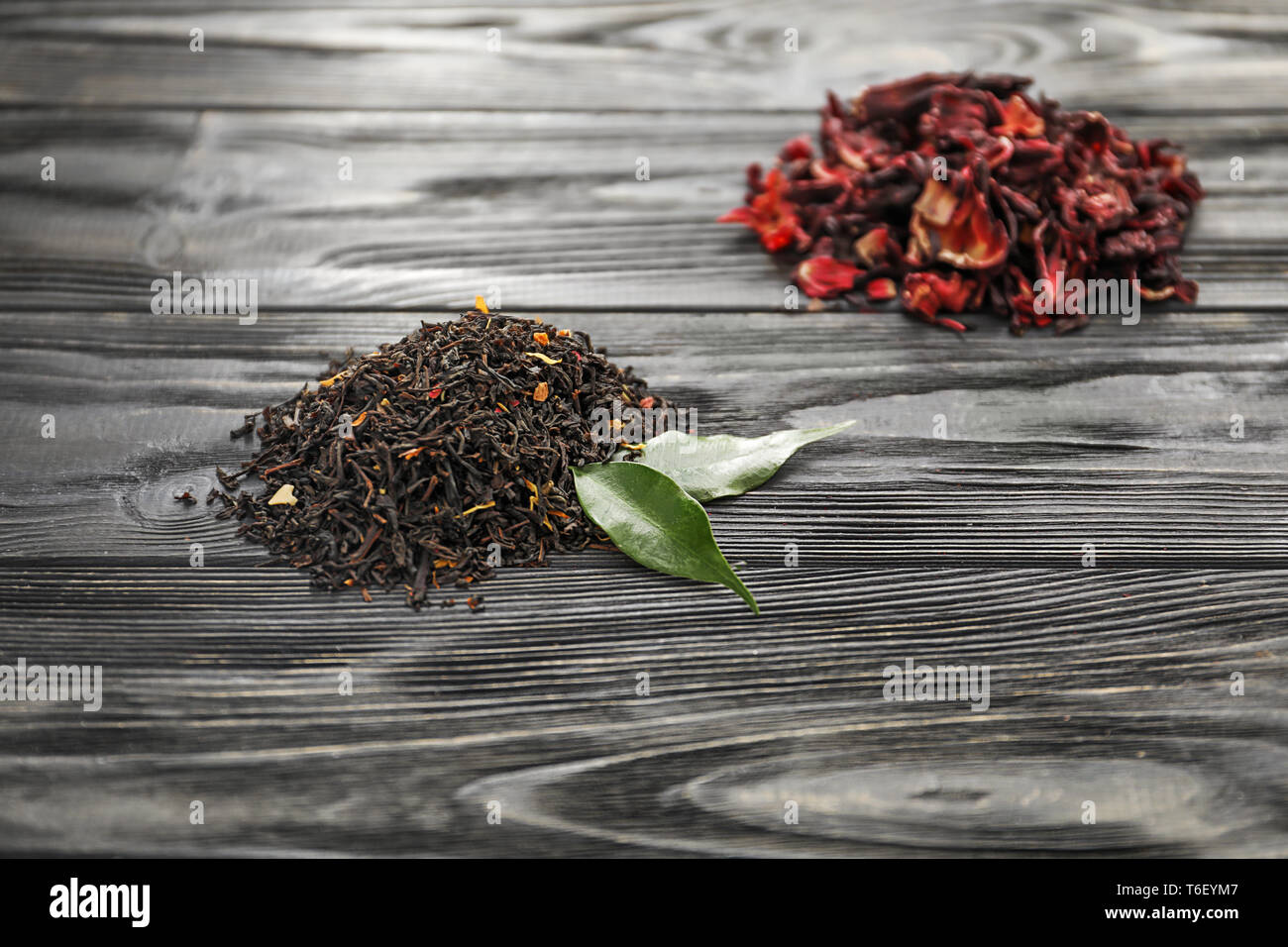 Different types of dry tea leaves on wooden background Stock Photo - Alamy