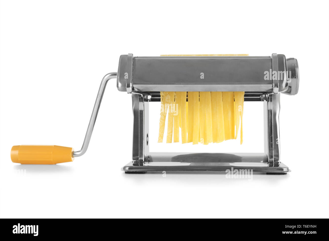 Metal pasta machine with dough on white background Stock Photo - Alamy