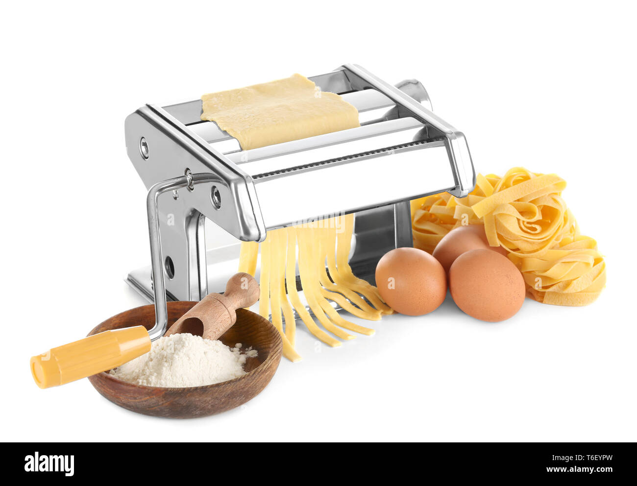 Metal pasta machine and products on white background Stock Photo - Alamy