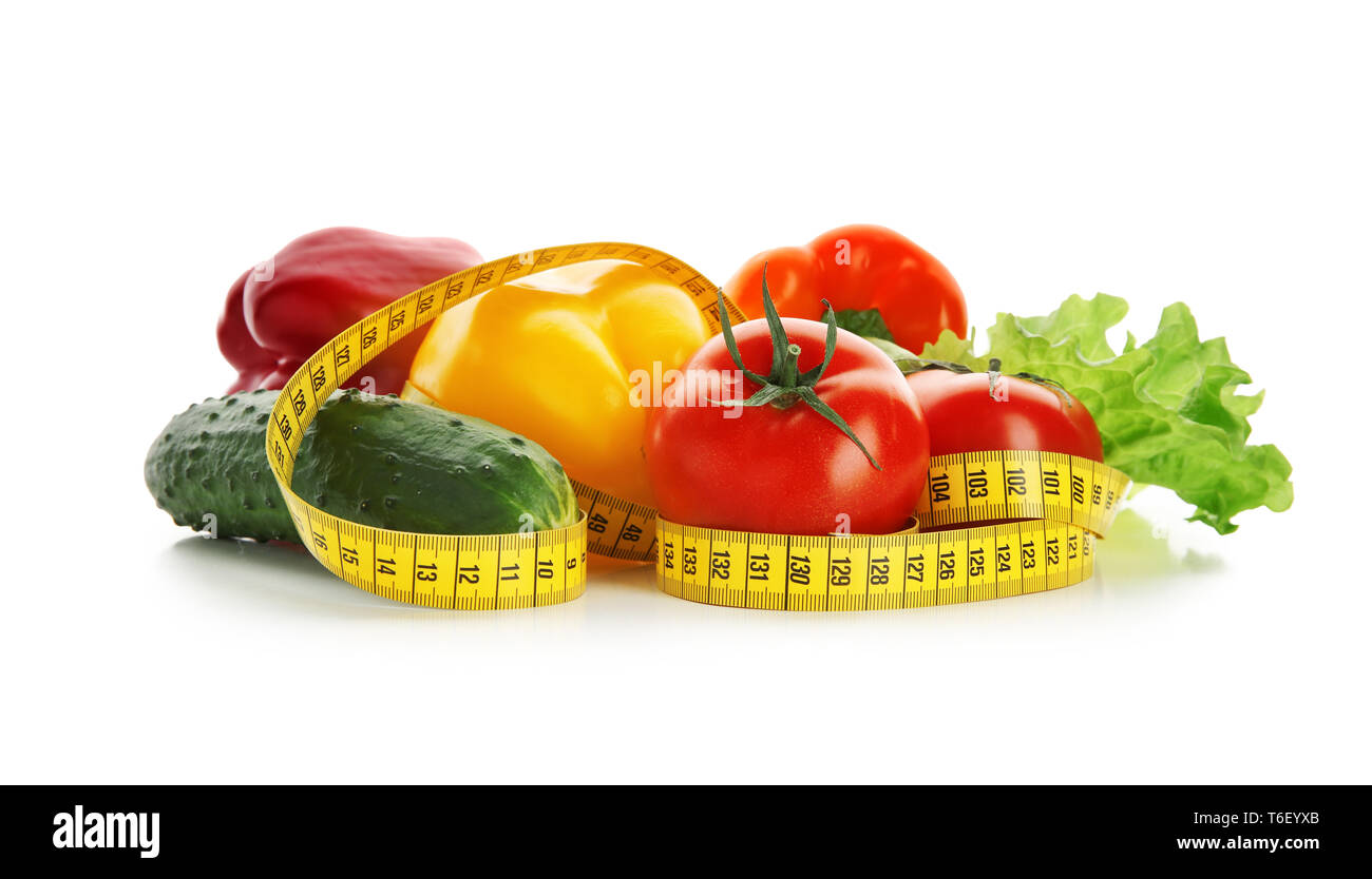 Vegetables and measuring tape on white background. Diet food Stock ...