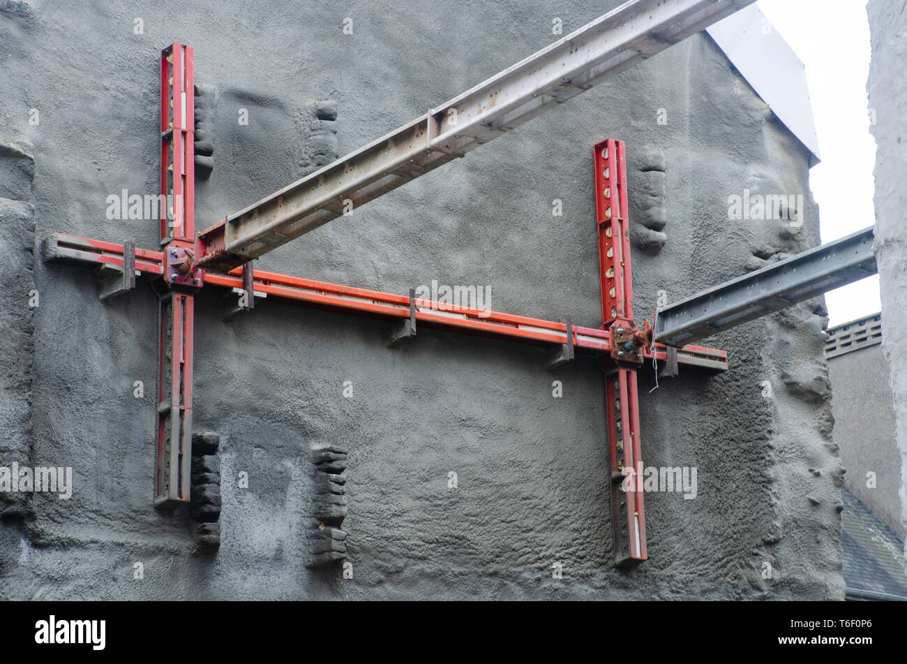 Horizontal beams holding up falling building being restored Stock Photo ...