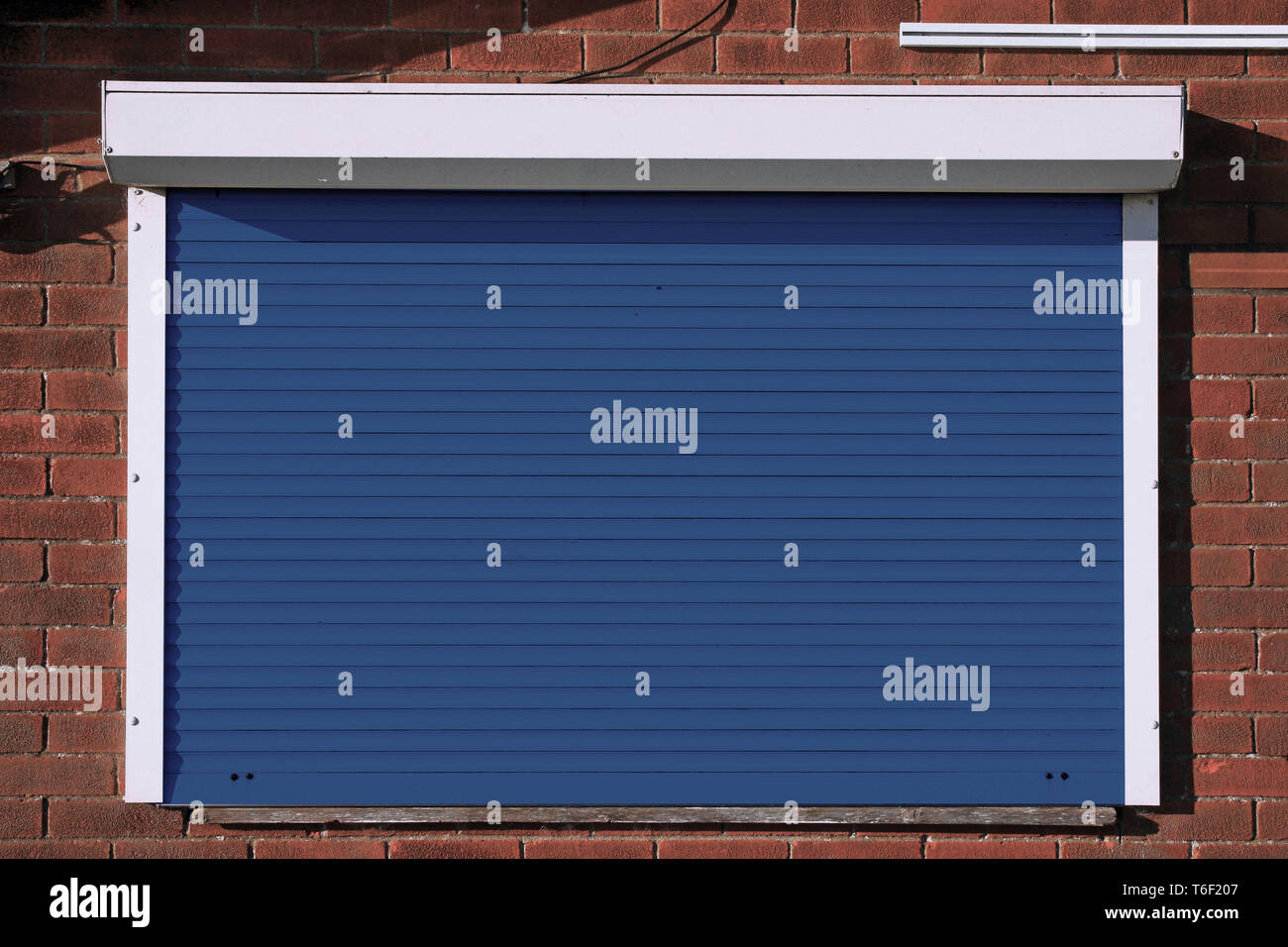 Closed blue security shutters Stock Photo - Alamy