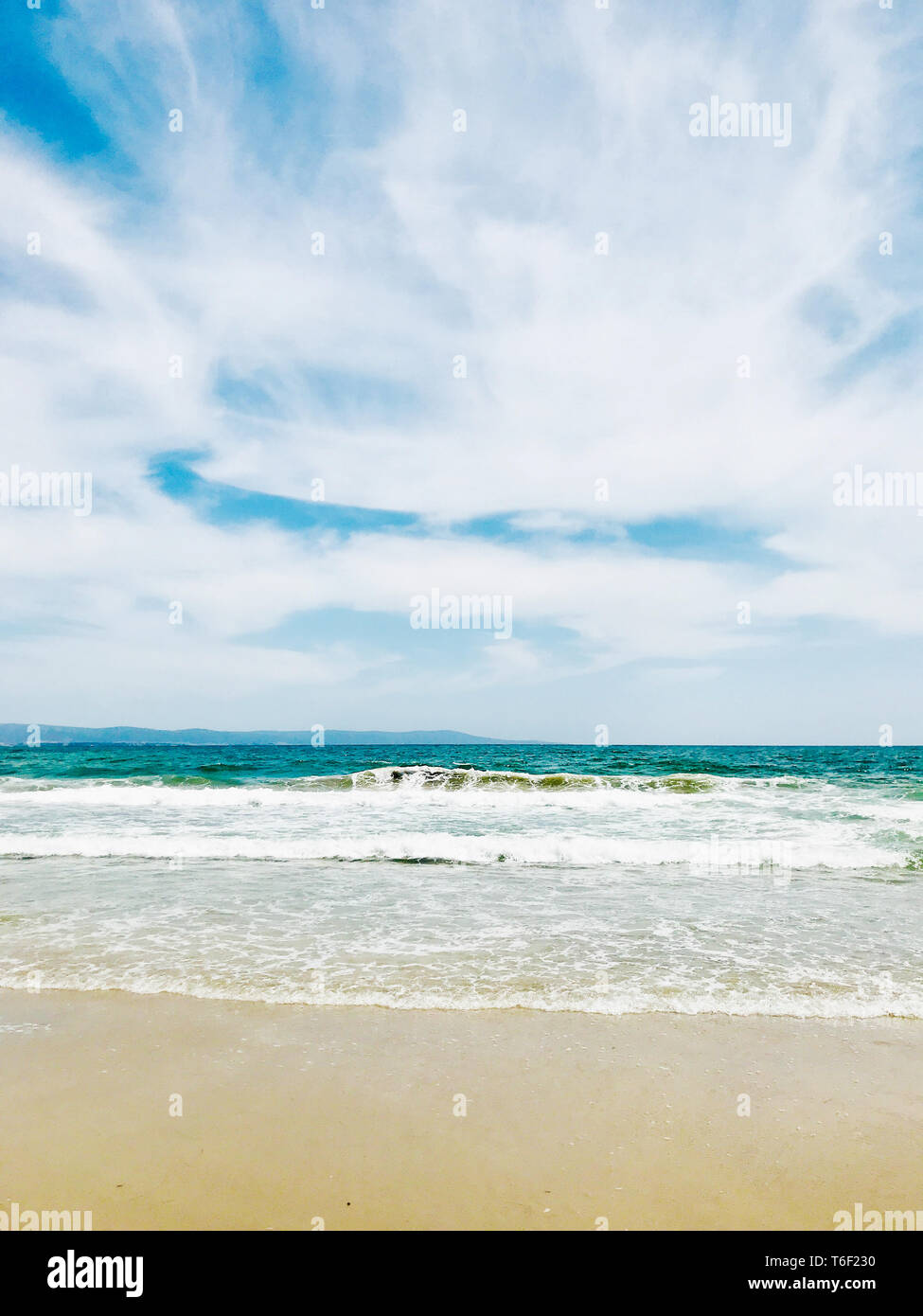 Beach and sea in bright sunlight Stock Photo - Alamy