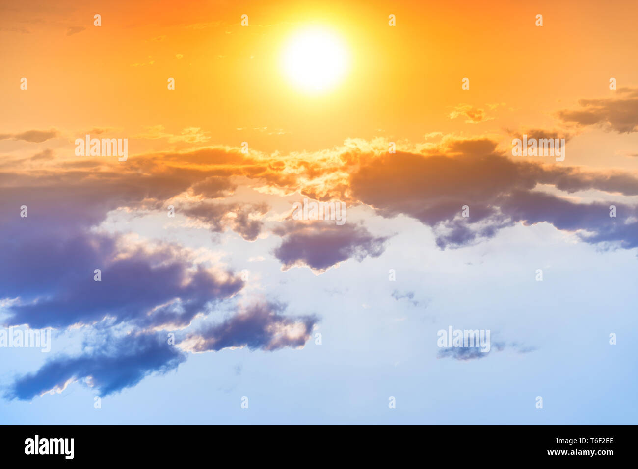 Sunset in the sky with big sun Stock Photo - Alamy