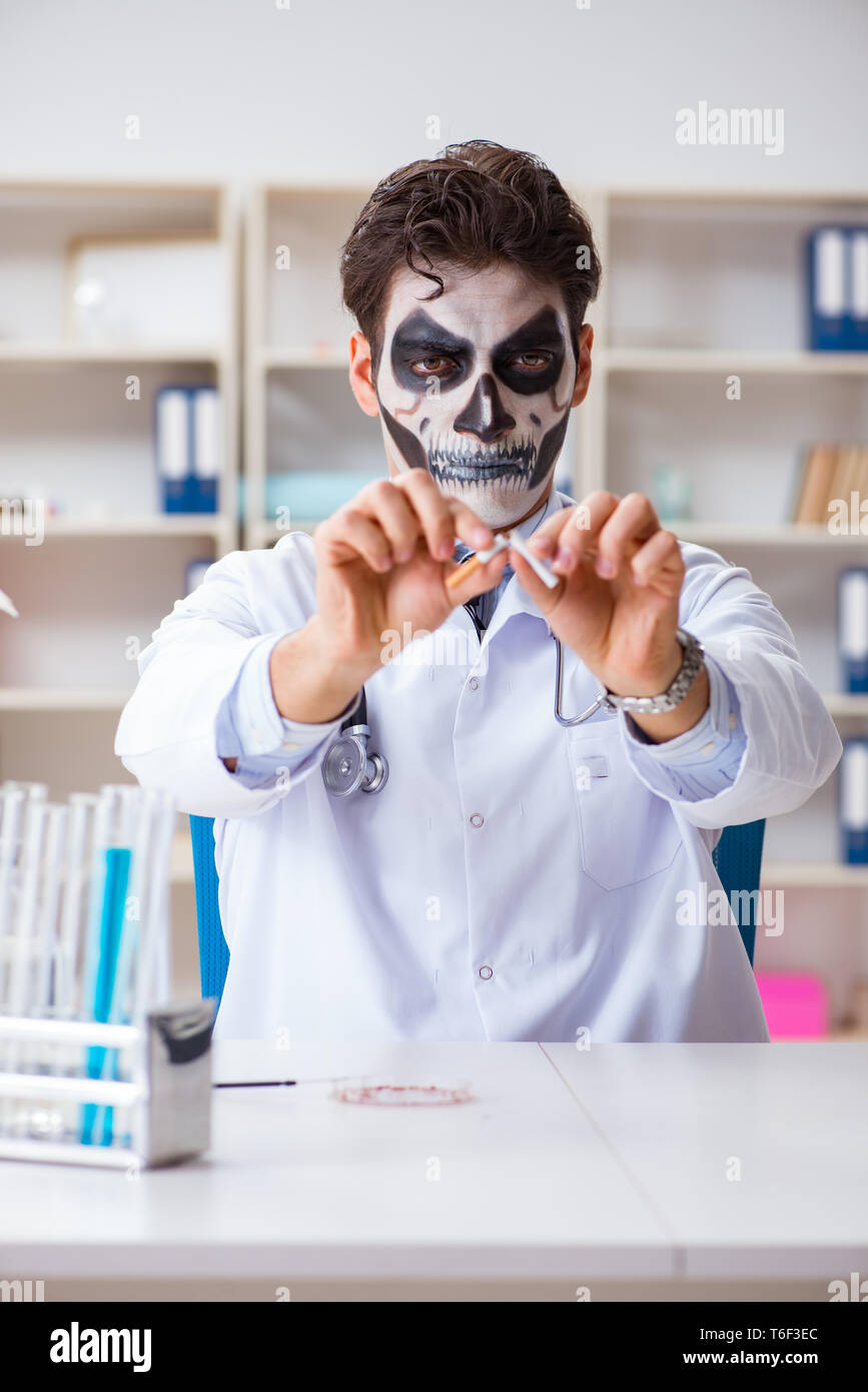 Scary monster doctor working in lab Stock Photo - Alamy