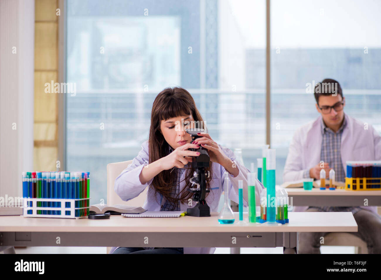 Two chemists working in lab experimenting Stock Photo - Alamy