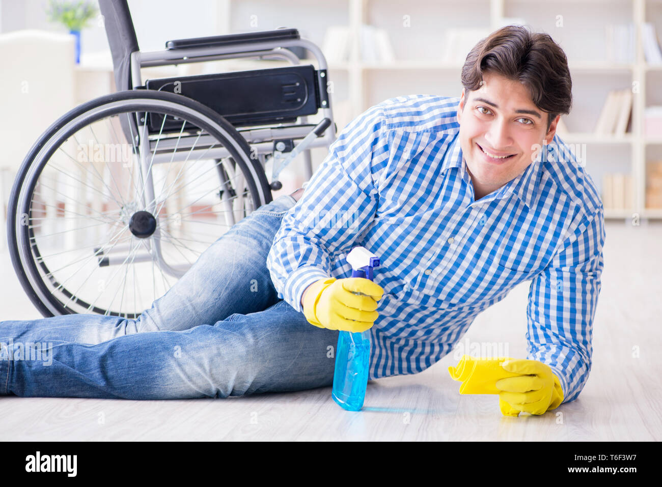 Disabled man on wheelchair cleaning home Stock Photo - Alamy