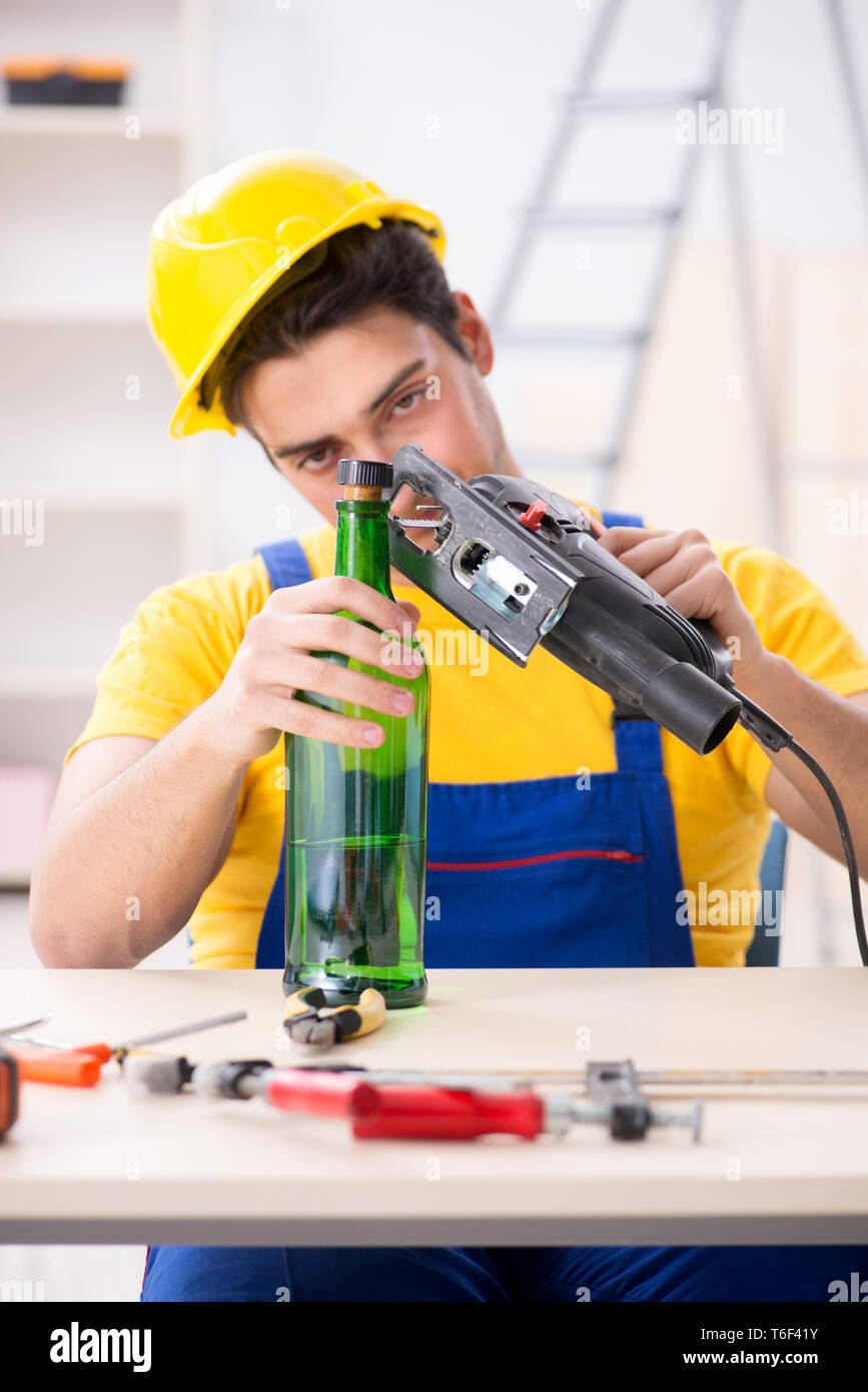 Drunk engineer working in the workshop Stock Photo - Alamy