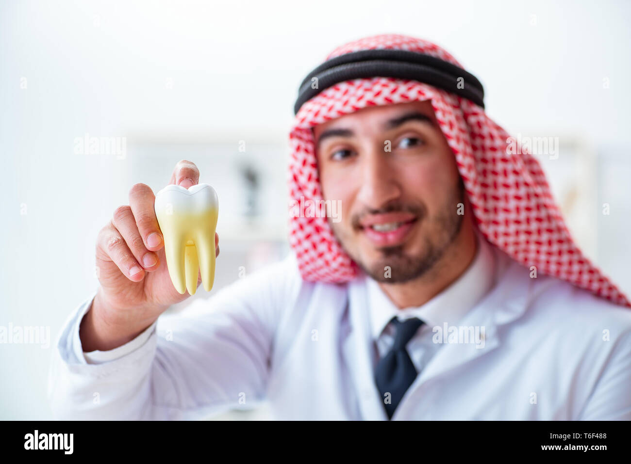 Arab dentist working on new teeth implant Stock Photo - Alamy