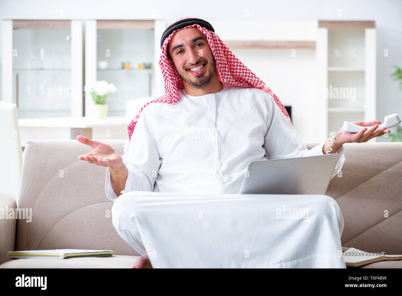 Arab man working at home on his work Stock Photo - Alamy