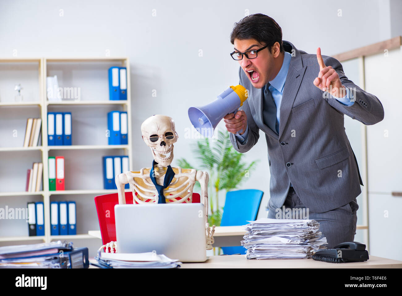 Angry boss yelling at his skeleton employee Stock Photo - Alamy