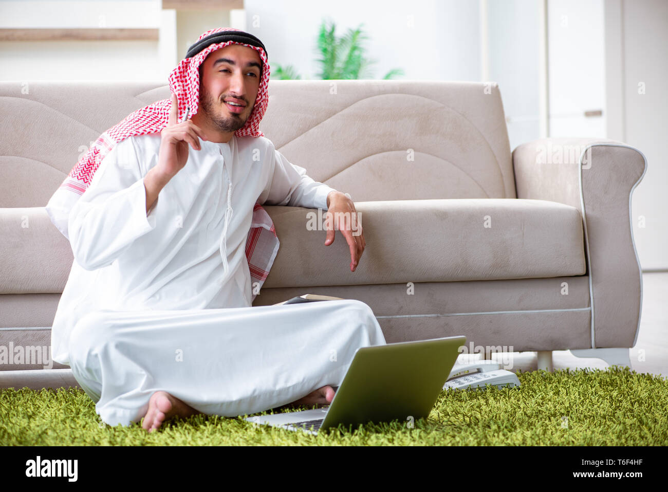 Arab man working at home on his work Stock Photo - Alamy