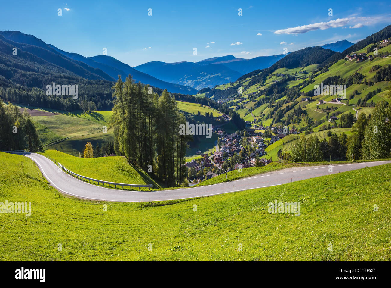 Road descends into the valley Stock Photo - Alamy