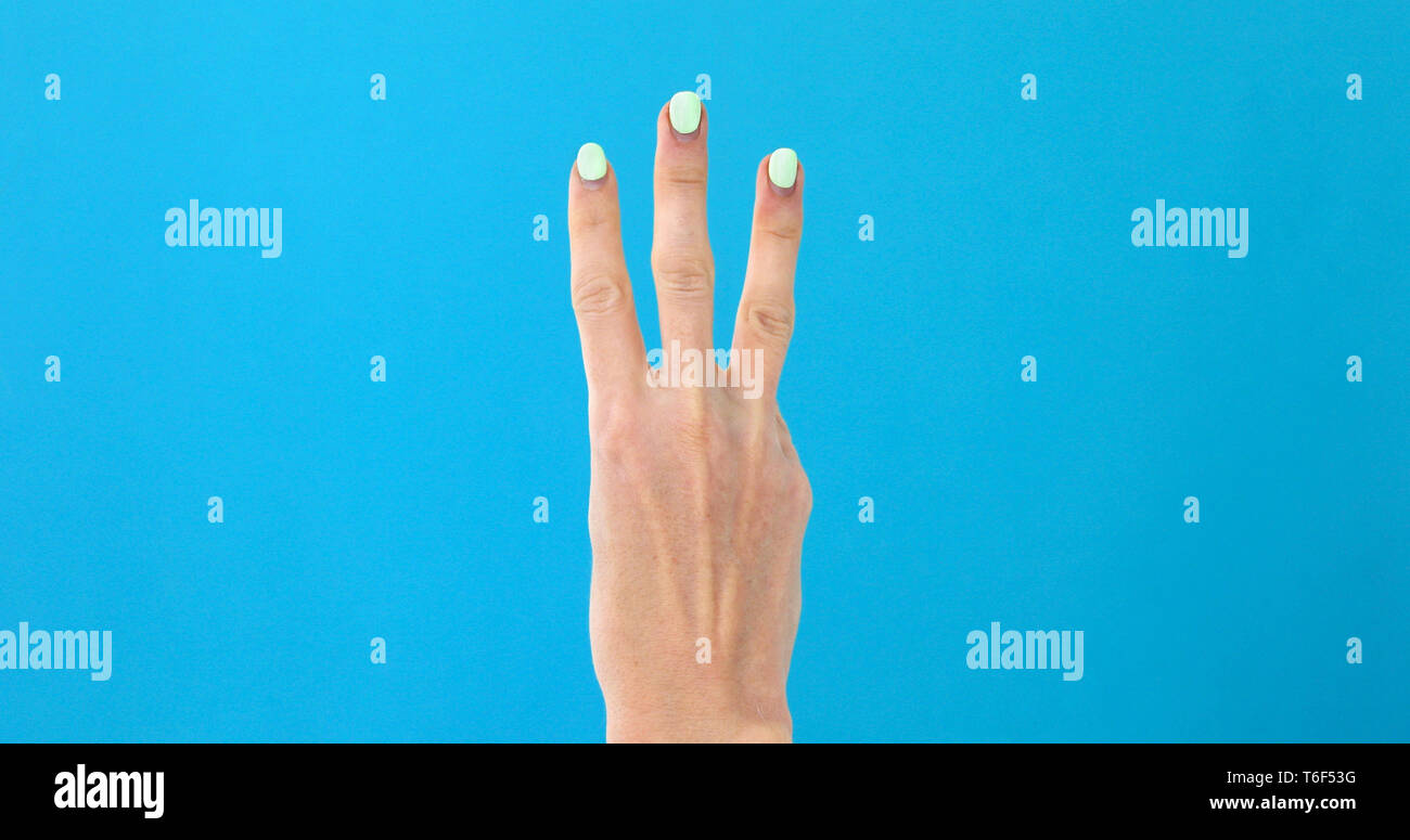 Closeup female hand counting from 3 Stock Photo - Alamy