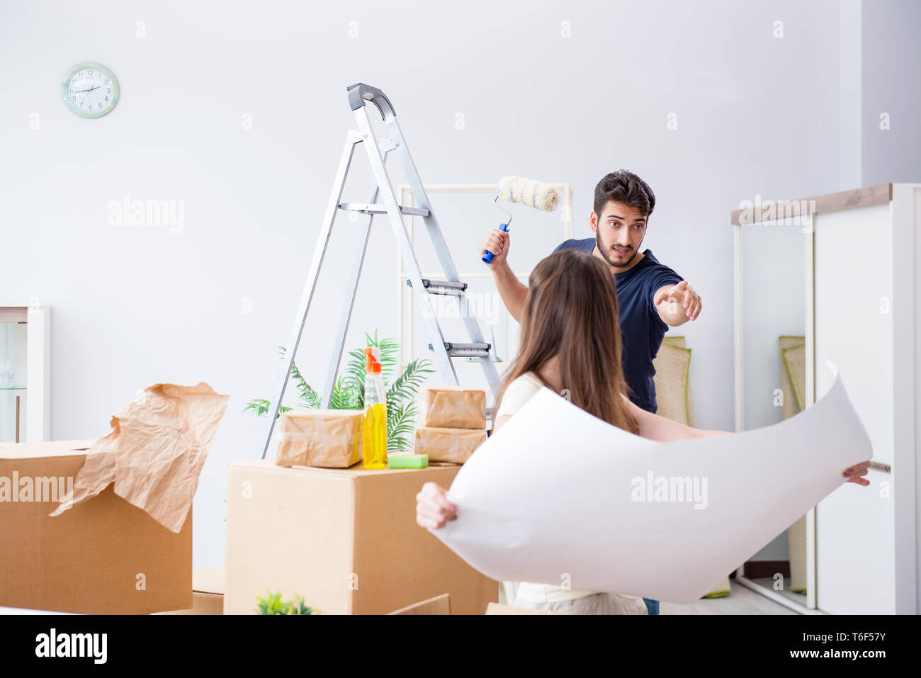 Young family unpacking at new house with boxes Stock Photo - Alamy