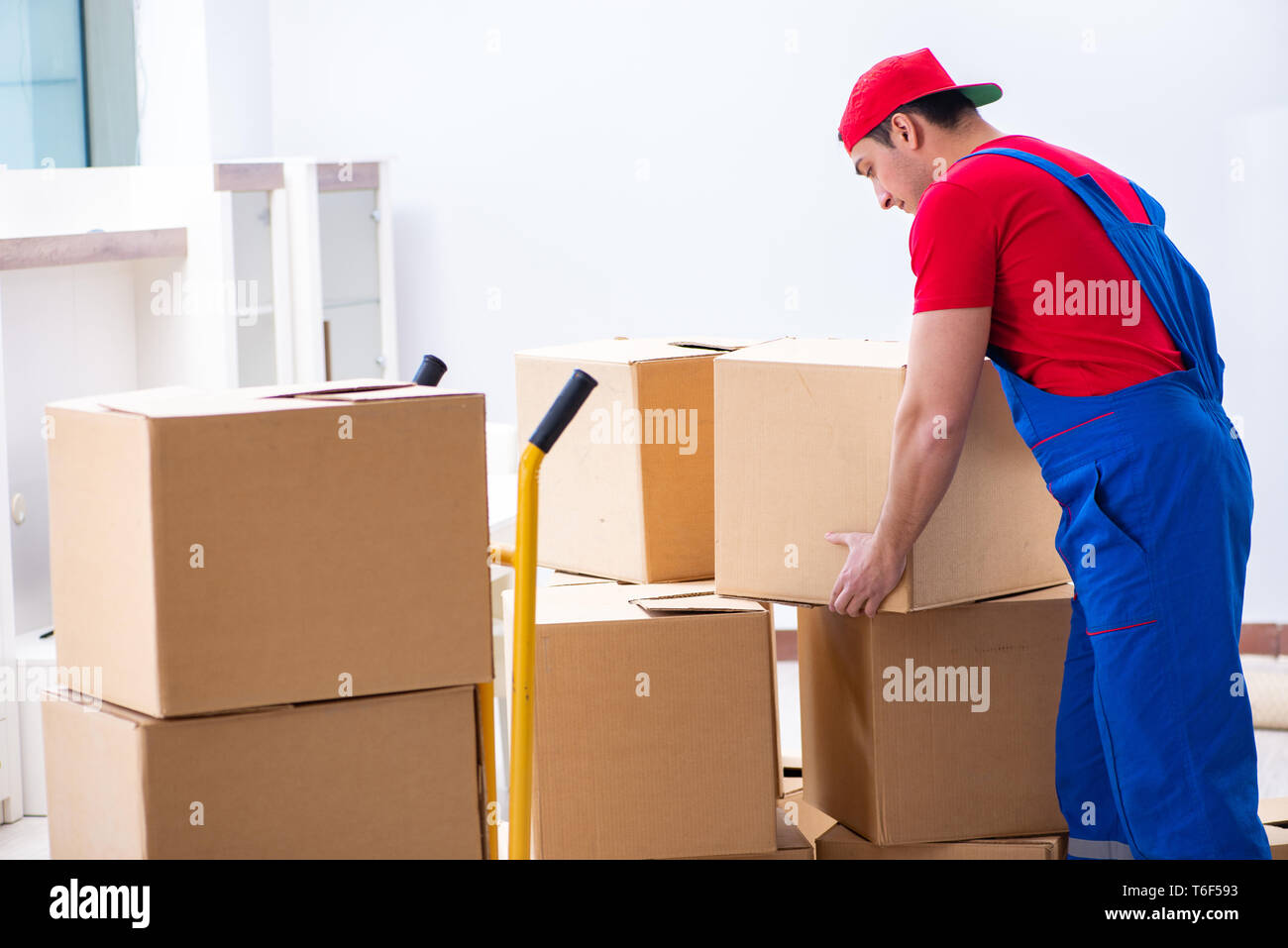 Contractor worker moving boxes during office move Stock Photo - Alamy