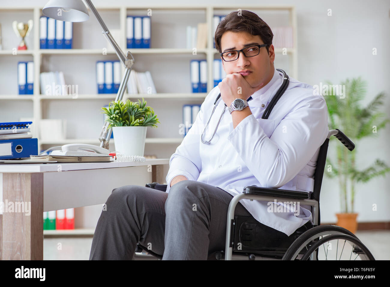 Disabled doctor on wheelchair working in hospital Stock Photo - Alamy