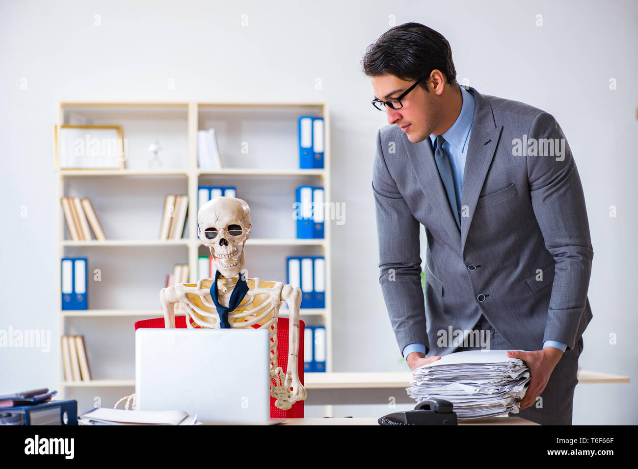 Angry boss yelling at his skeleton employee Stock Photo - Alamy