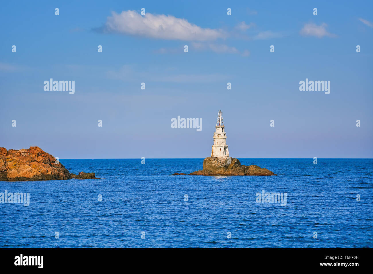 Small Lighthouse in the Sea Stock Photo - Alamy
