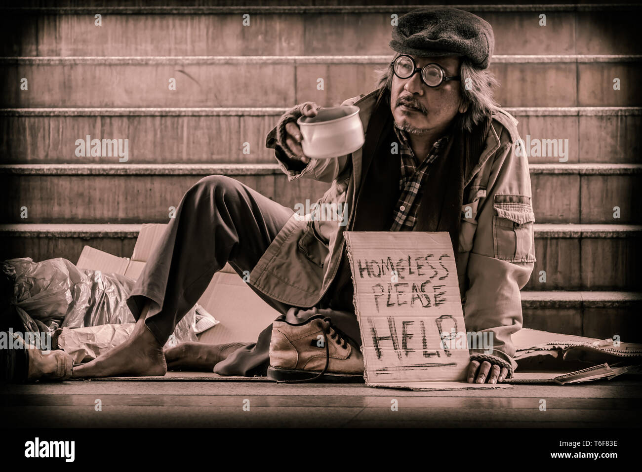 Man in need. Unhappy homeless man is holding hands to get help ...