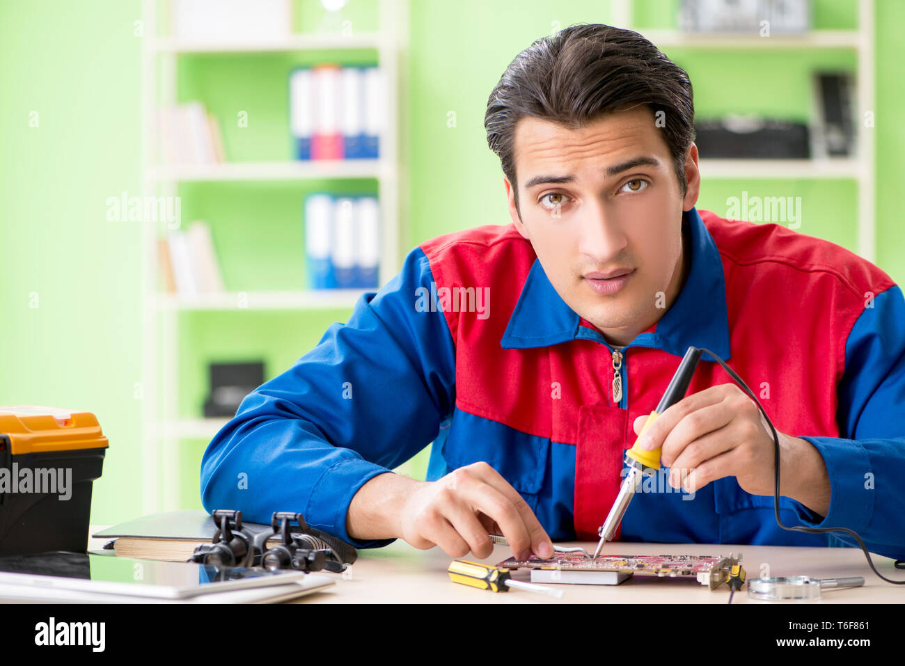 Computer engineer repairing broken desktop Stock Photo - Alamy