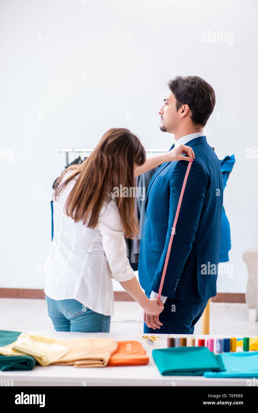 Professional tailor taking measurements for formal suit Stock Photo - Alamy