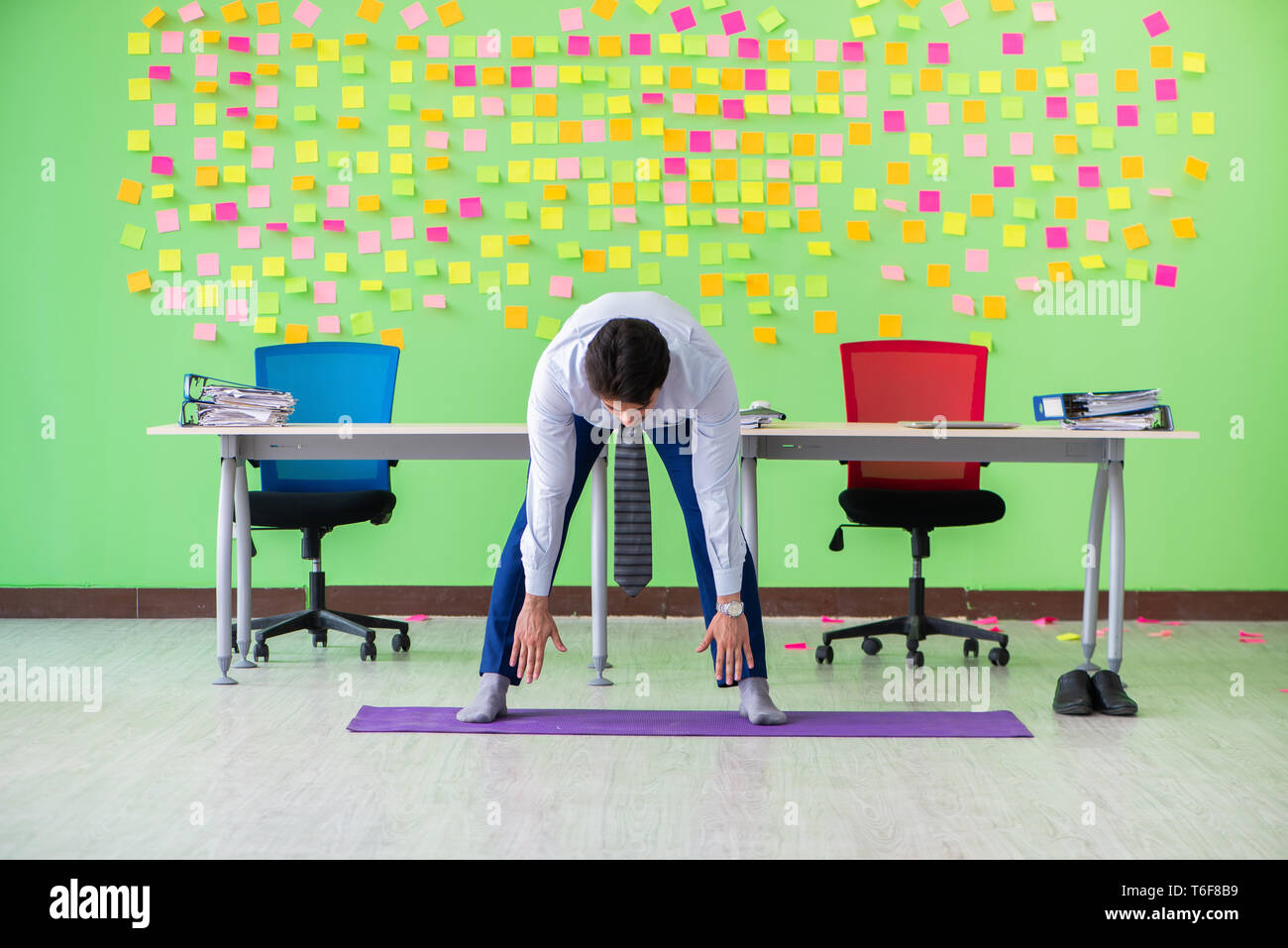 Man in the office with many conflicting priorities doing exercis Stock ...