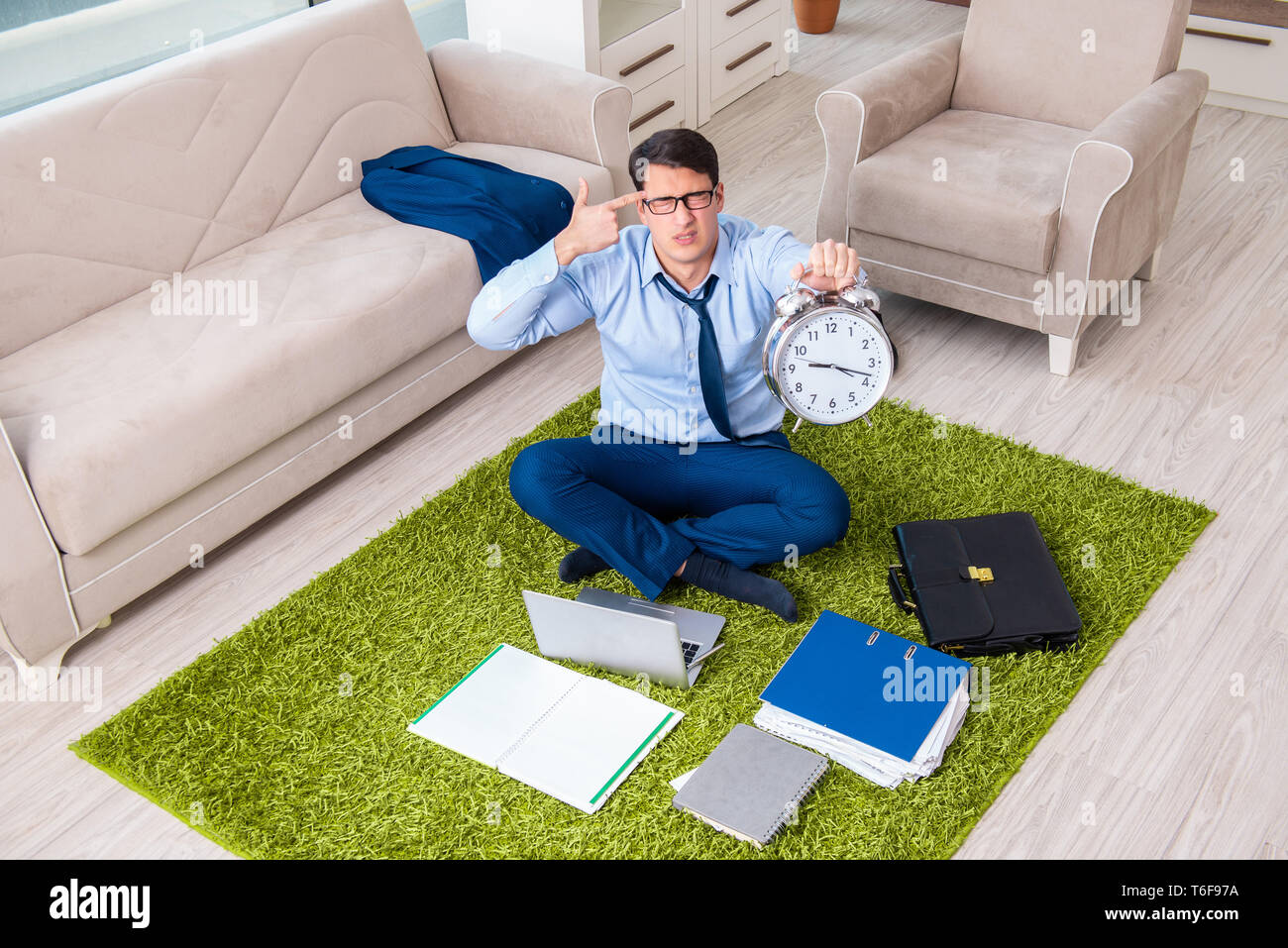 Businessman taking work home and working overtime Stock Photo - Alamy