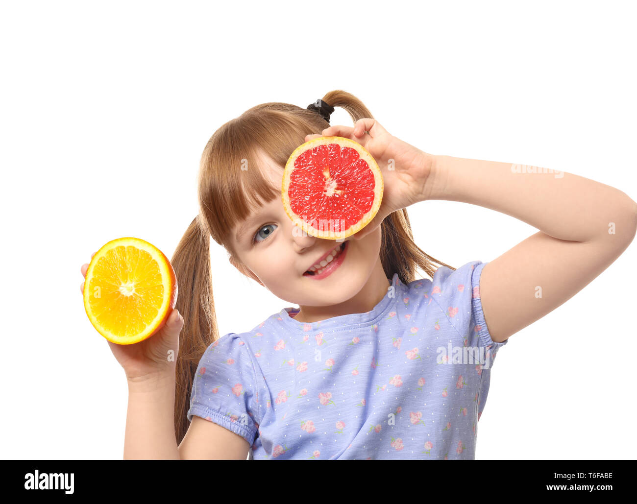 Cute little girl with citrus fruits on white background Stock Photo - Alamy