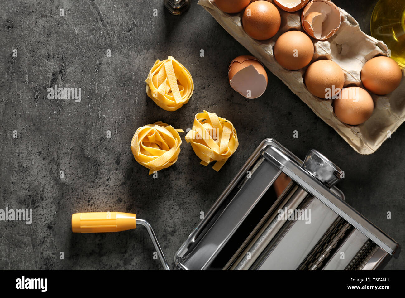 Metal pasta maker and products on kitchen table, top view Stock Photo ...