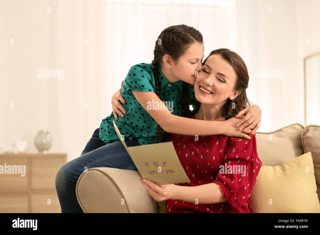 Little girl greeting her mother at home Stock Photo - Alamy
