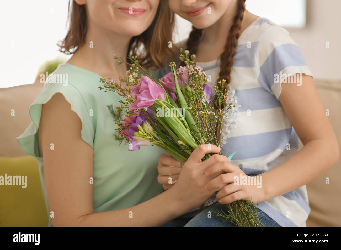 Cute little girl greeting mother at home Stock Photo - Alamy