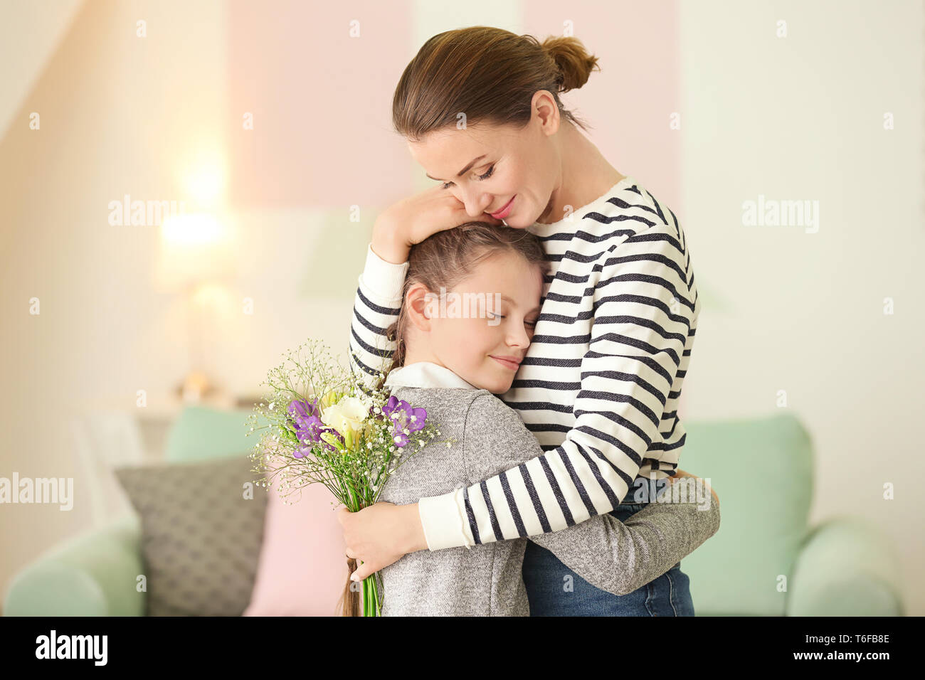 Little girl greeting her mother at home Stock Photo - Alamy