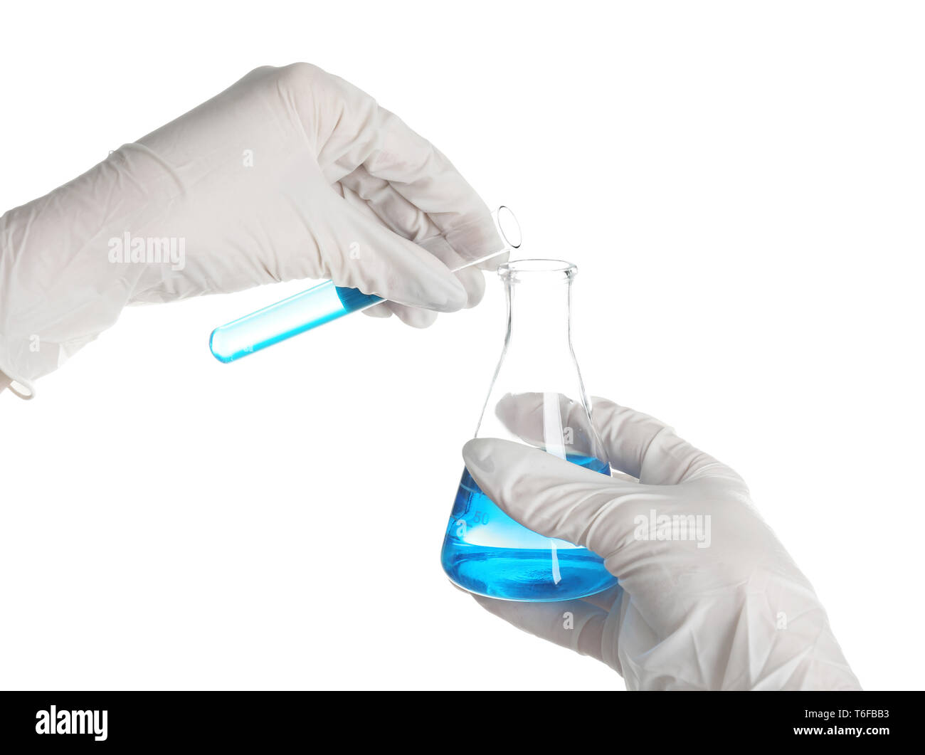 Woman pouring blue liquid from test tube into flask on white background ...