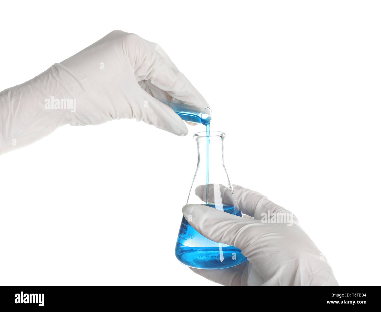 Woman pouring blue liquid from test tube into flask on white background ...