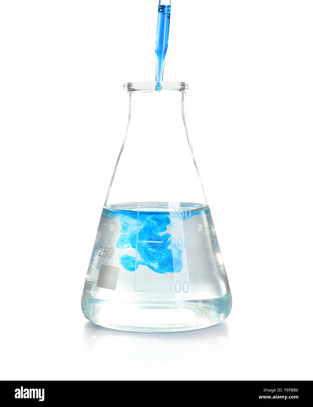 Dripping blue liquid into laboratory glassware on white background ...