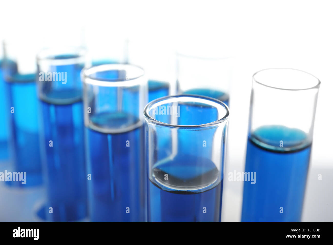 Test tubes with blue liquid on white background Stock Photo - Alamy