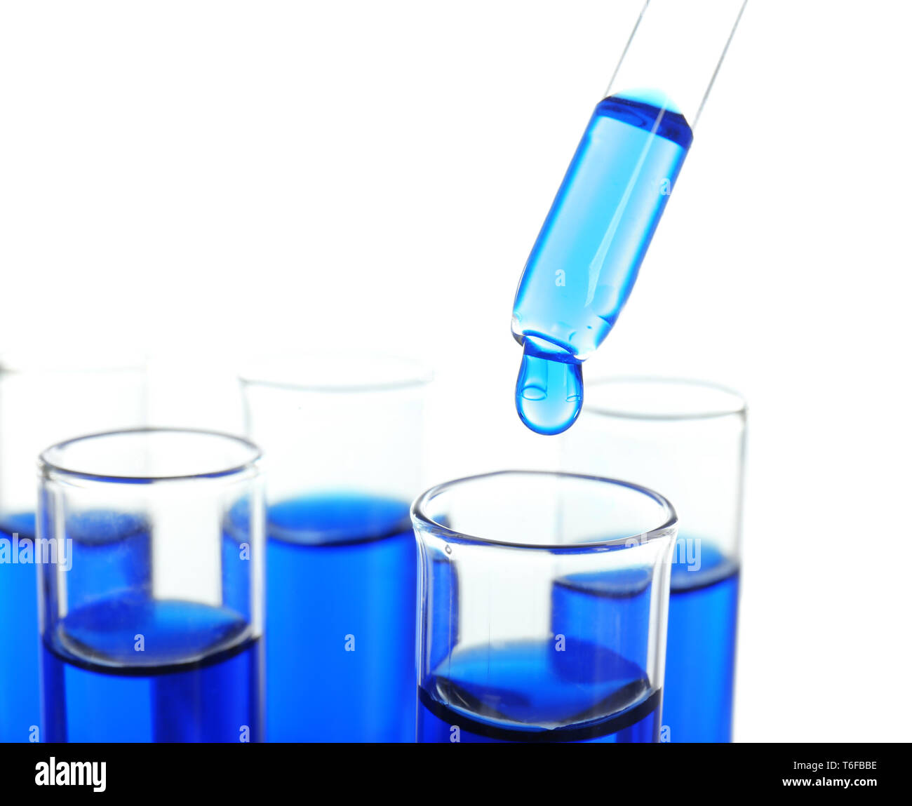 Dripping blue liquid into test tubes on white background Stock Photo ...