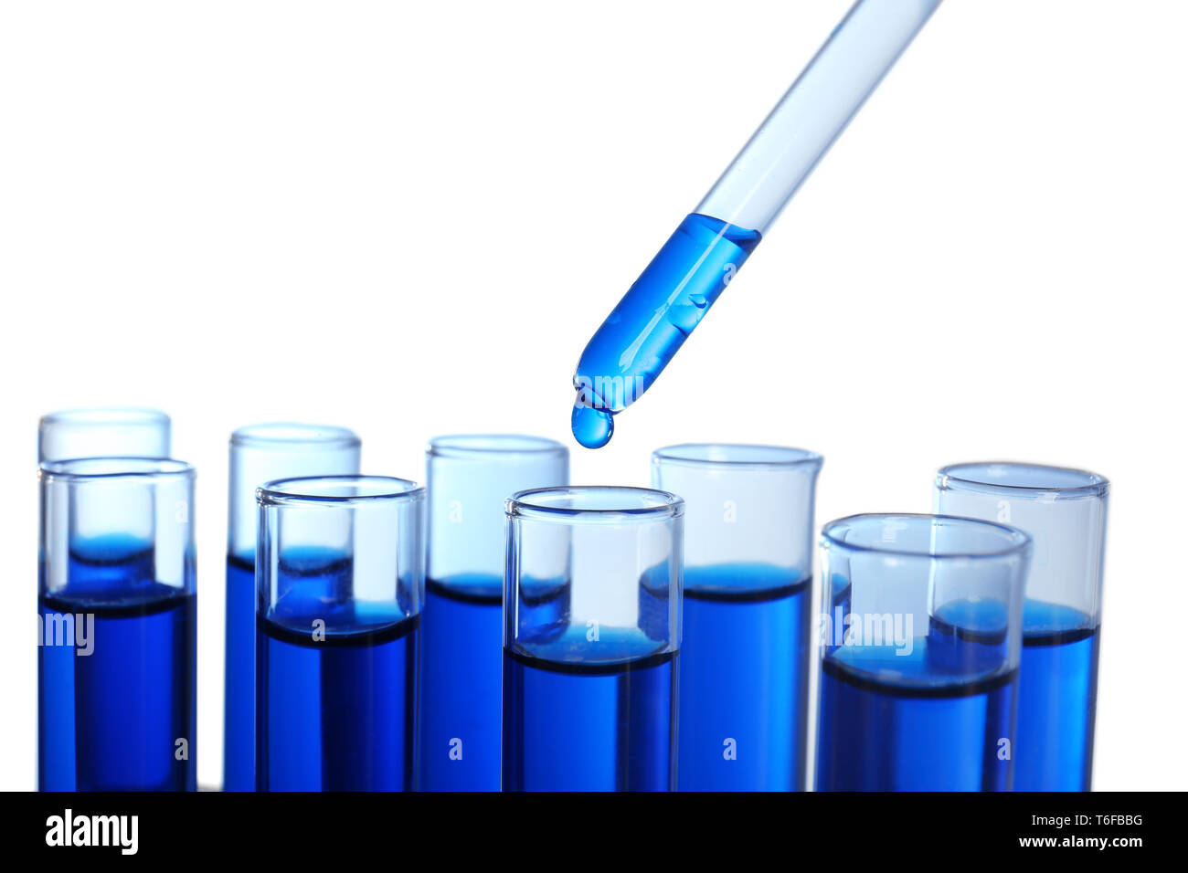 Dripping blue liquid into test tubes on white background Stock Photo ...