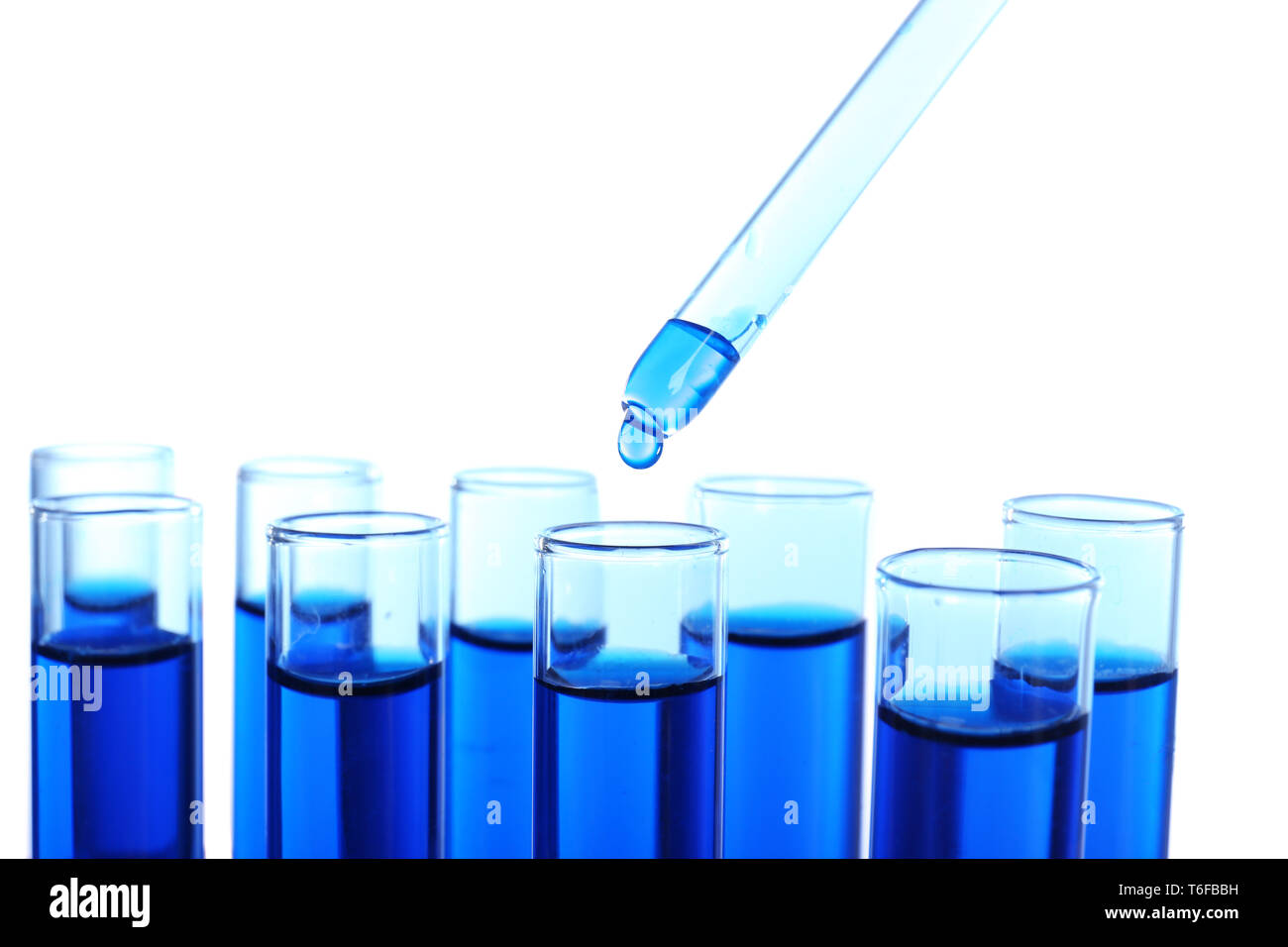 Dripping blue liquid into test tubes on white background Stock Photo ...