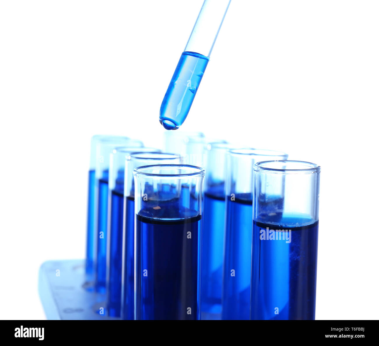 Dripping blue liquid into test tubes on white background Stock Photo ...