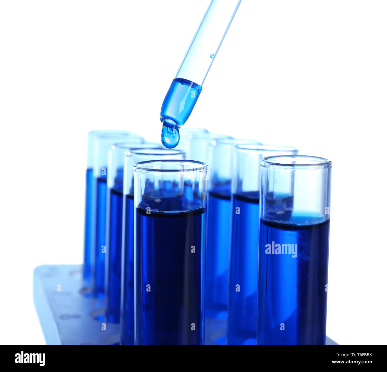 Dripping blue liquid into test tubes on white background Stock Photo ...