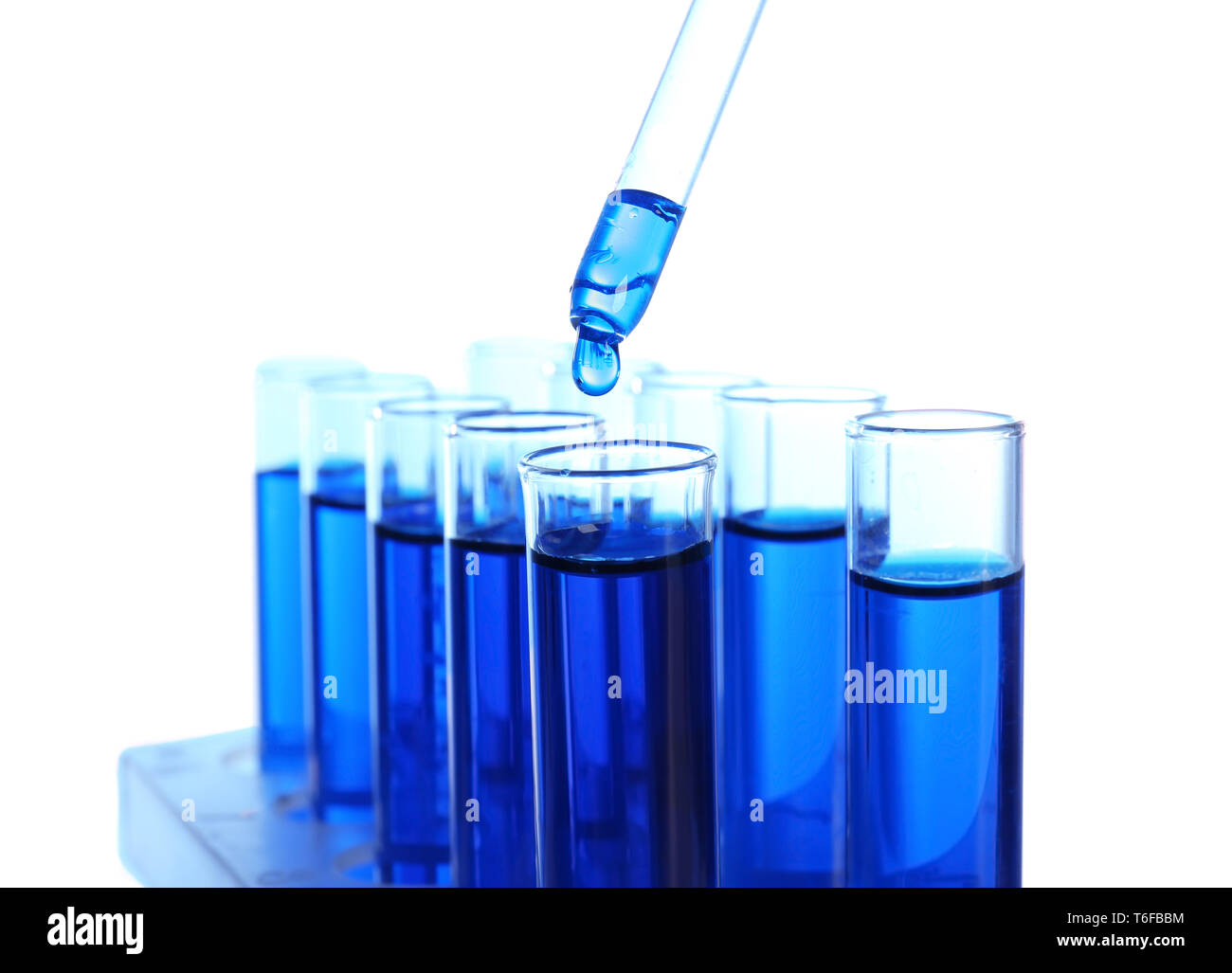 Dripping blue liquid into test tubes on white background Stock Photo ...