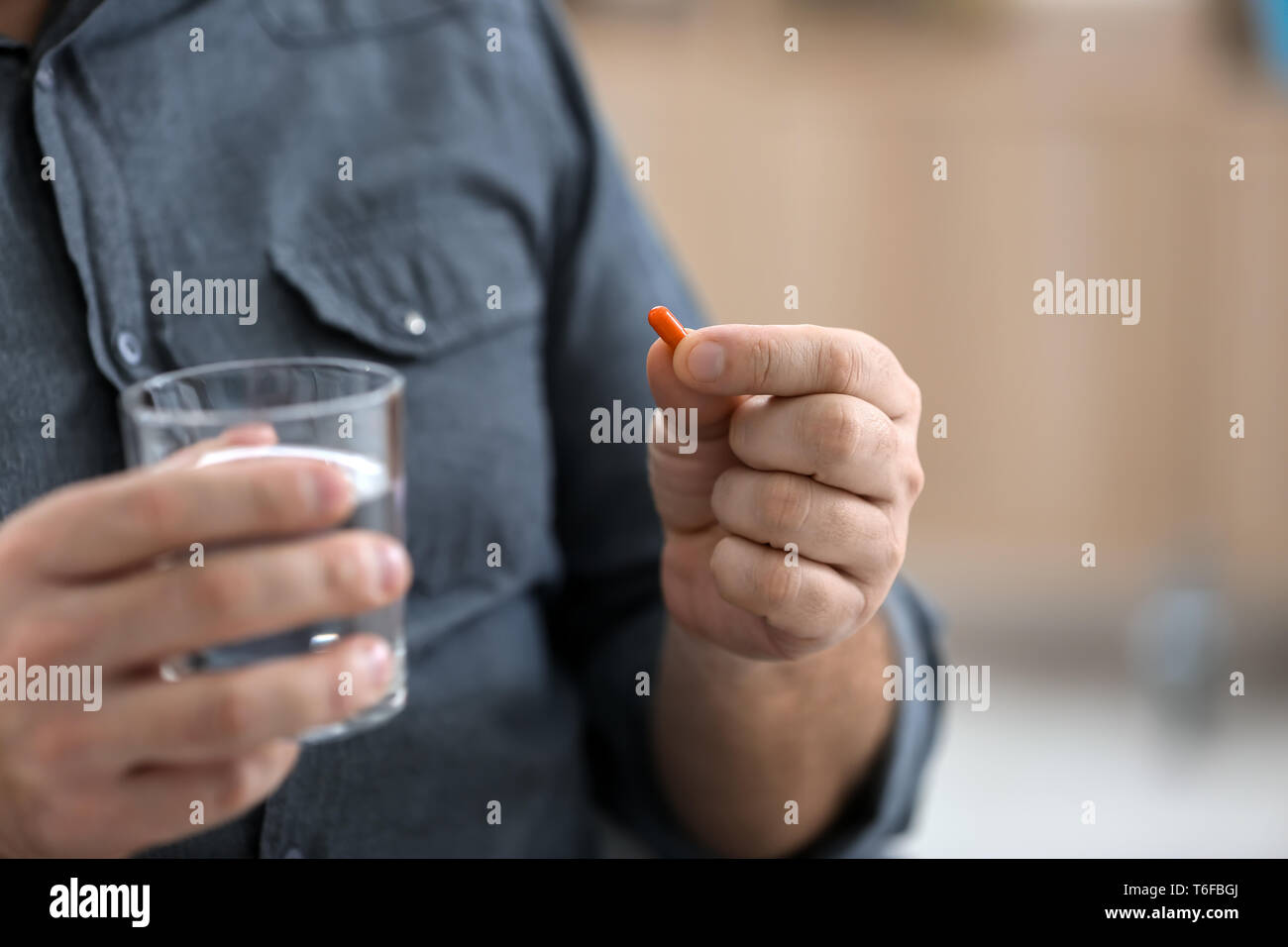 Mature man taking pill hi-res stock photography and images - Alamy