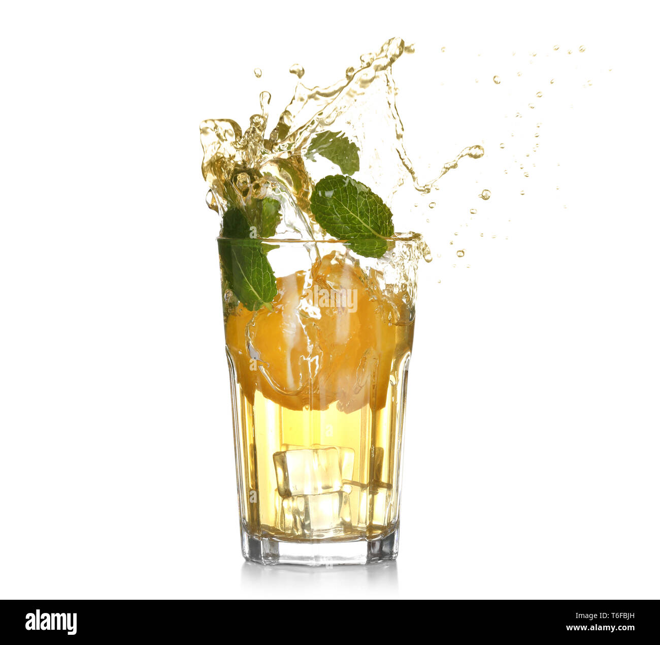 Glass of splashing lemonade with citrus fruit on white background Stock ...